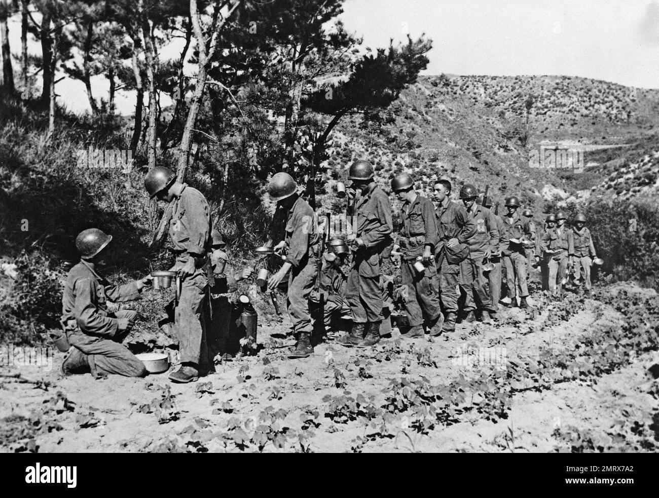 U.S. troops line up for chow during a lull in the fighting against ...