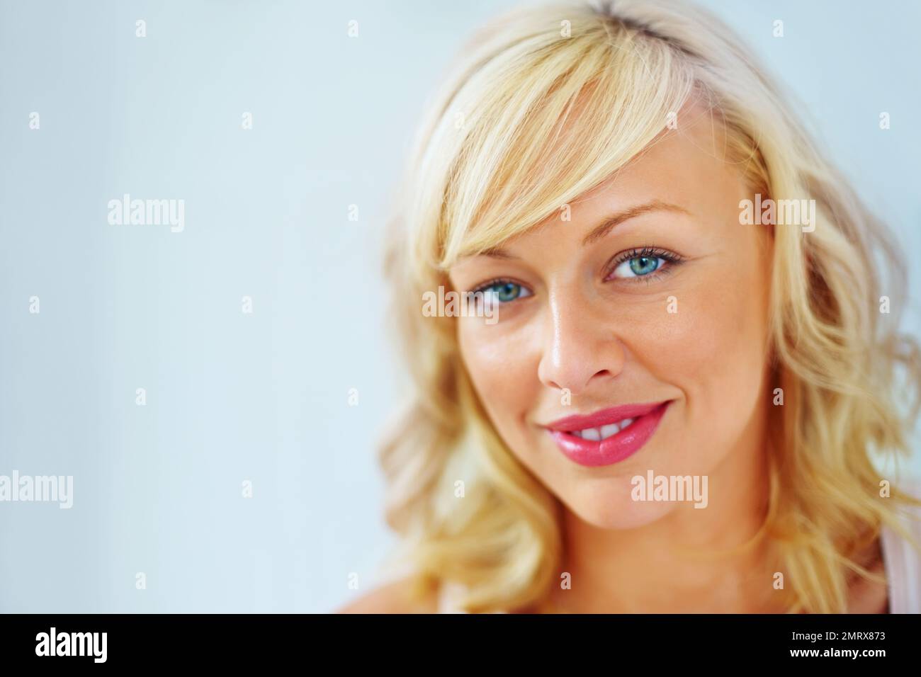 Beautiful mature female smiling against white background. Closeup of a ...