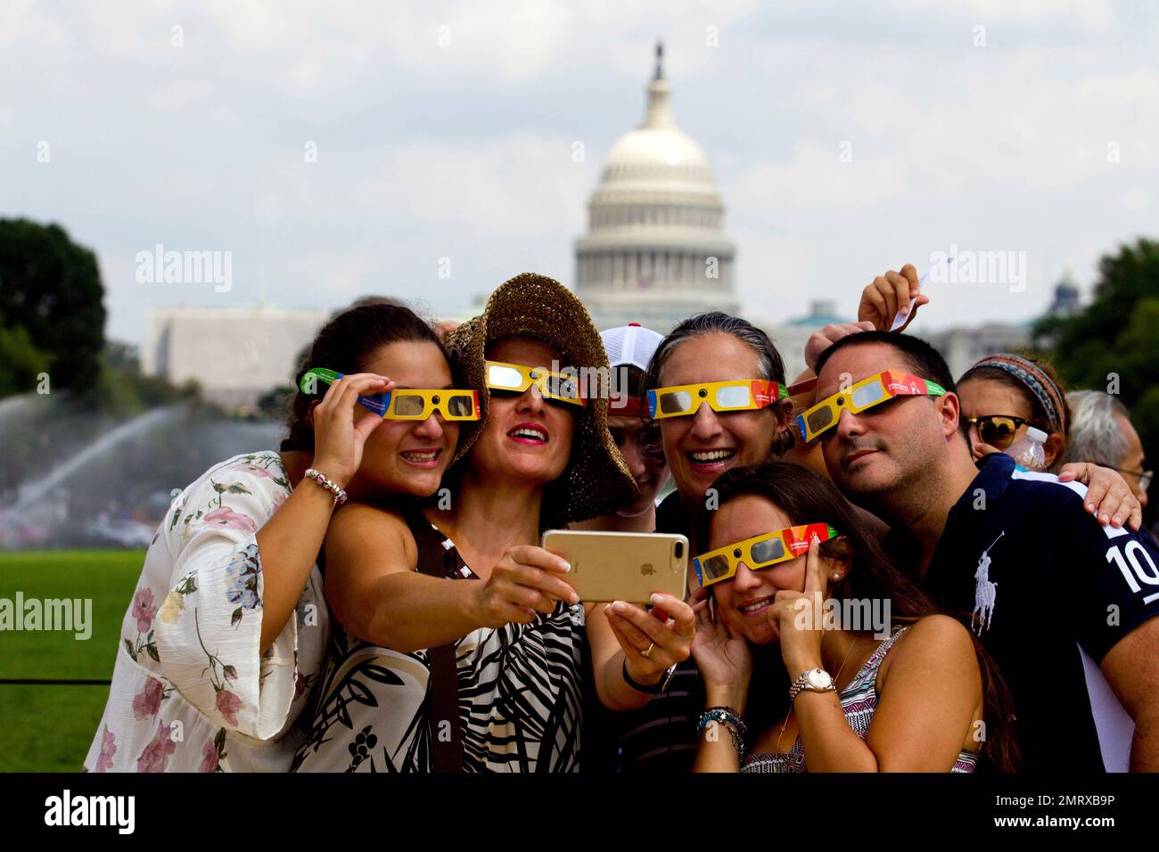 A family takes a selfie wearing a safety glasses to watch phases of ...