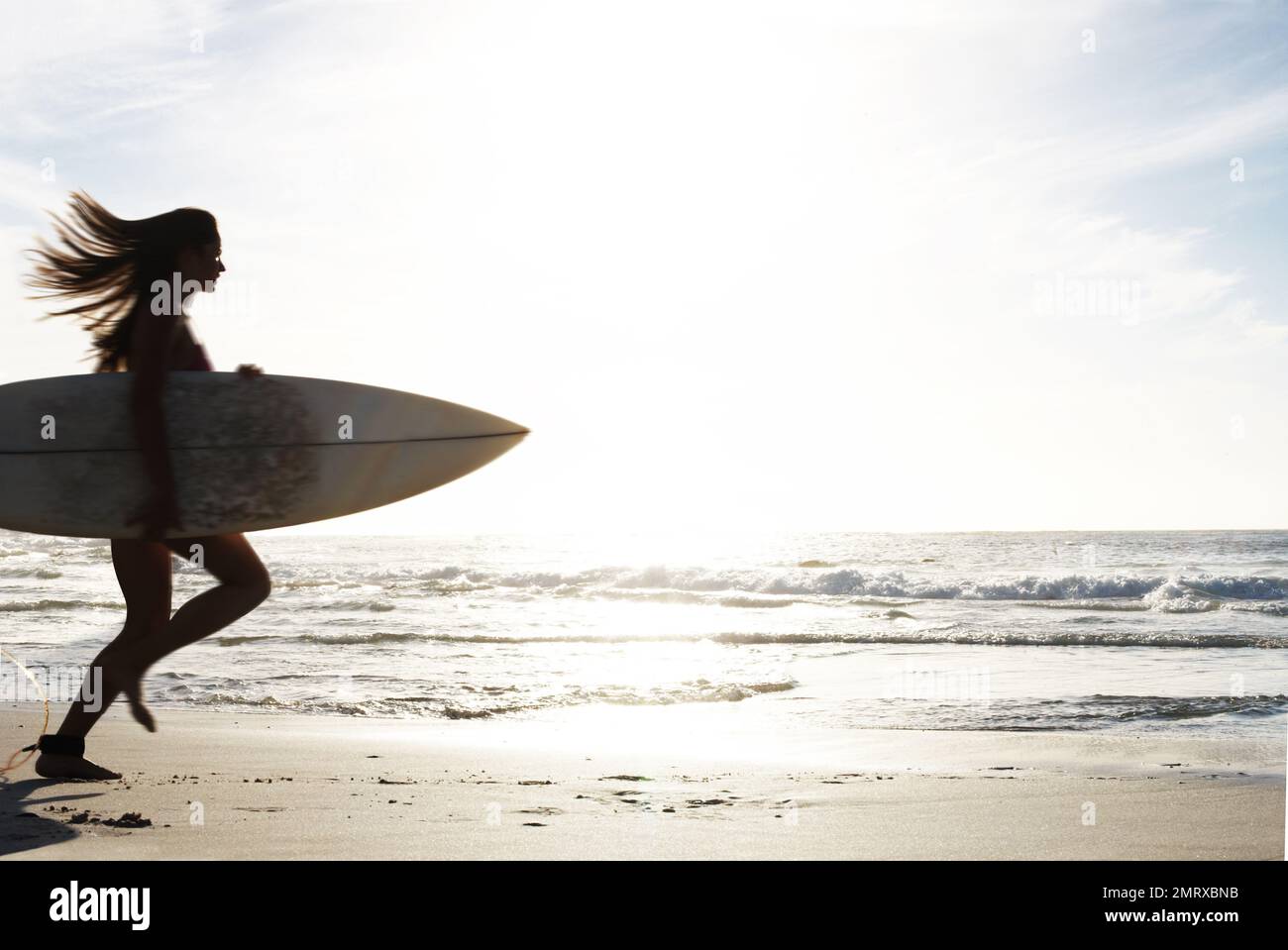 Professional female surfer going for surfing. Portrait of a young ...
