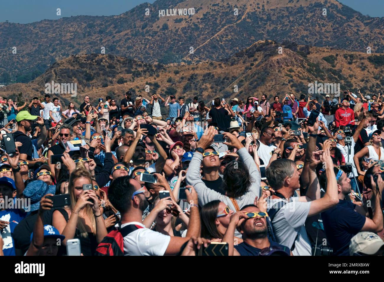 A large crowd gathers in front of the Hollywood sign at the Griffith ...