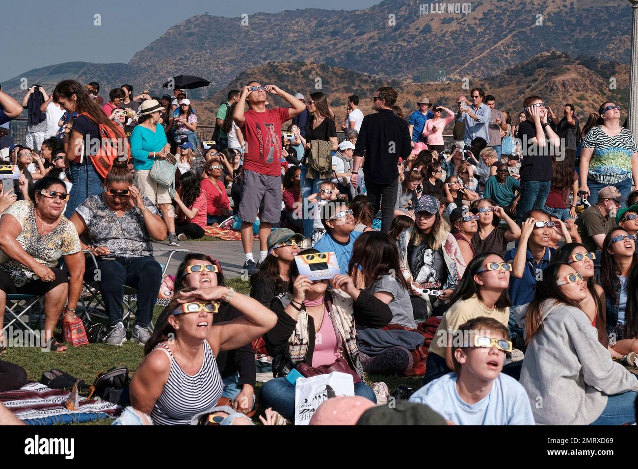 A large crowd gathers in front of the Hollywood sign at the Griffith ...