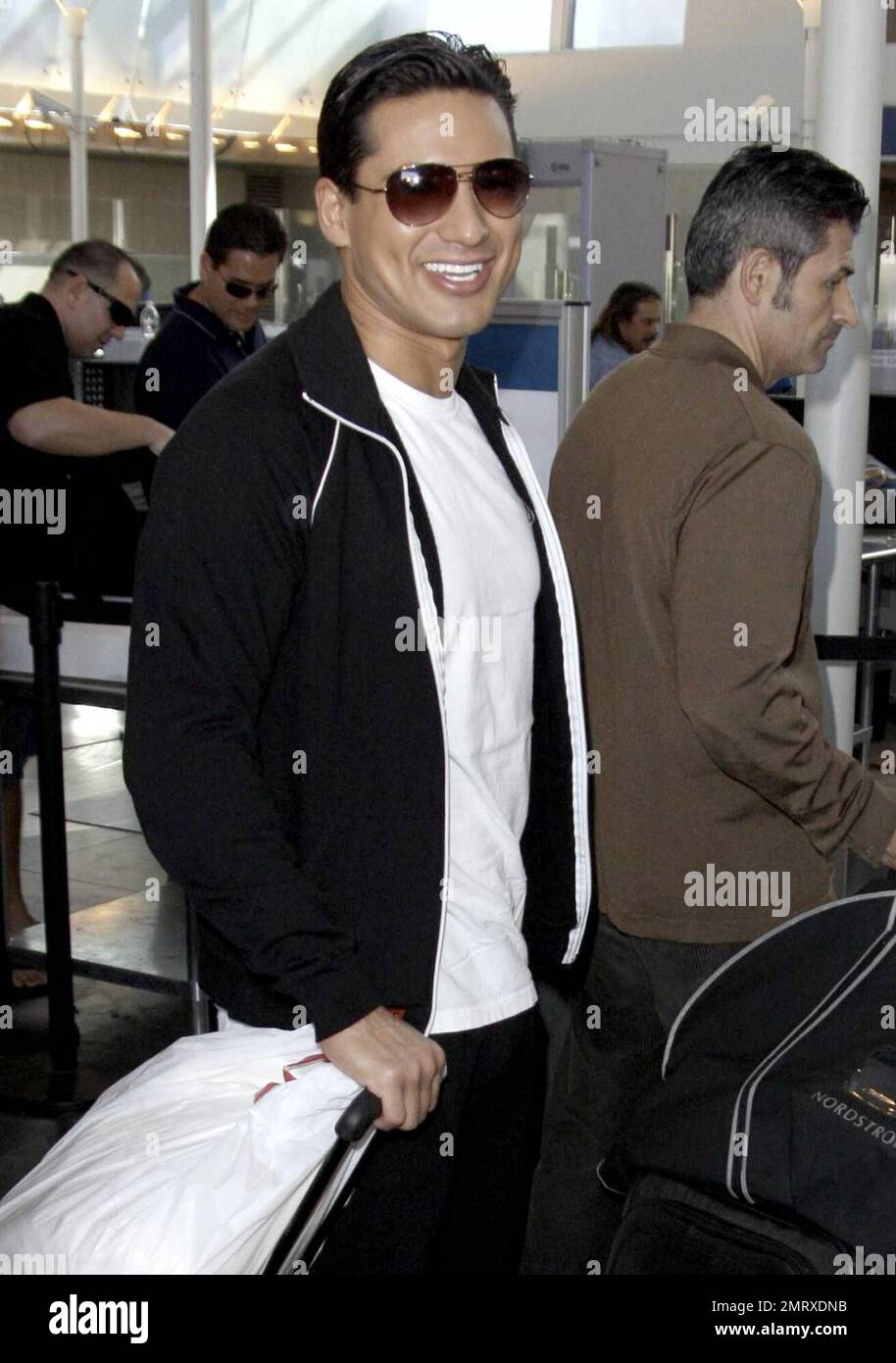 Mario Lopez heads through the line at a security checkpoint inside LAX ...