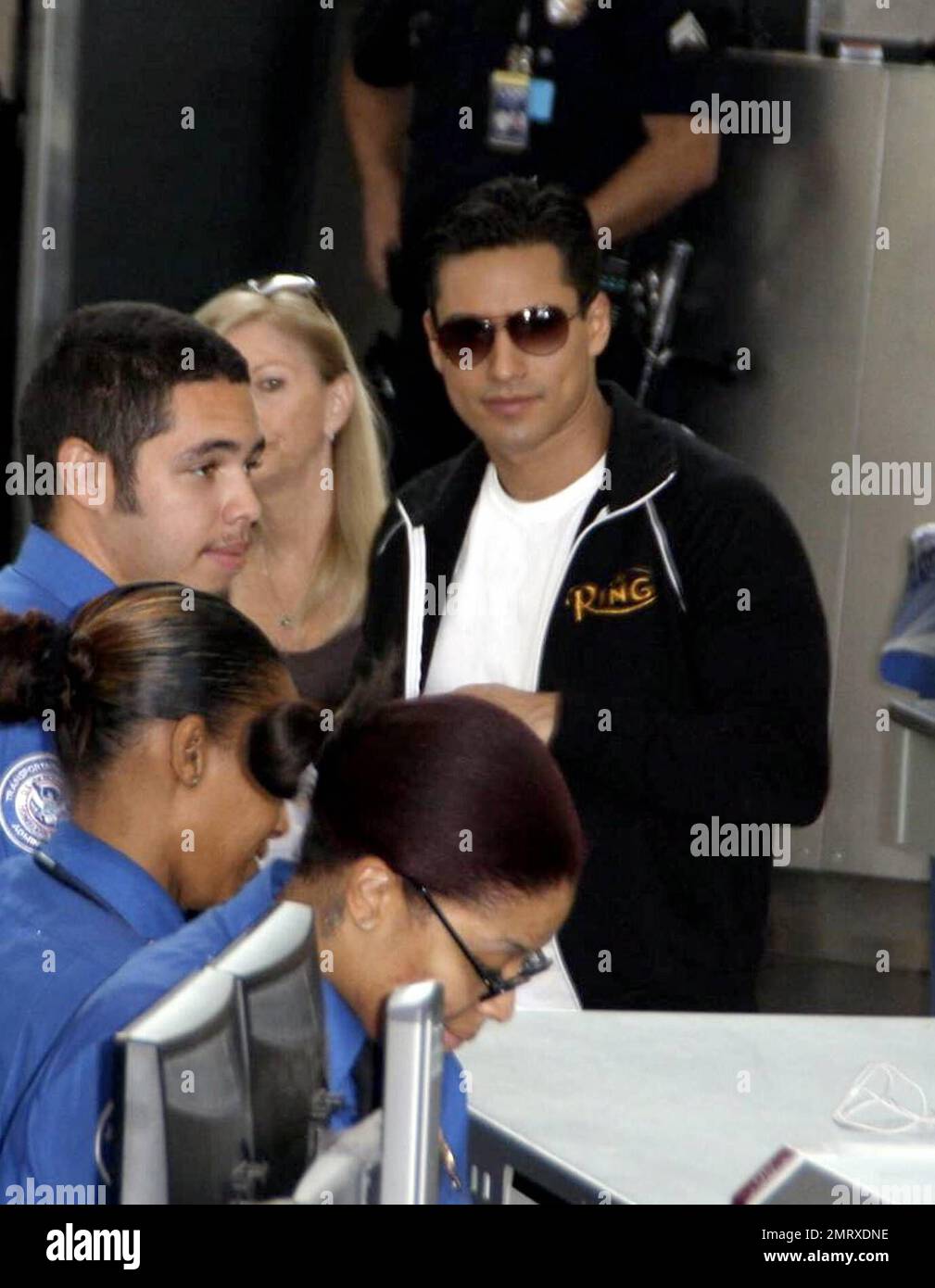 Mario Lopez heads through the line at a security checkpoint inside LAX ...