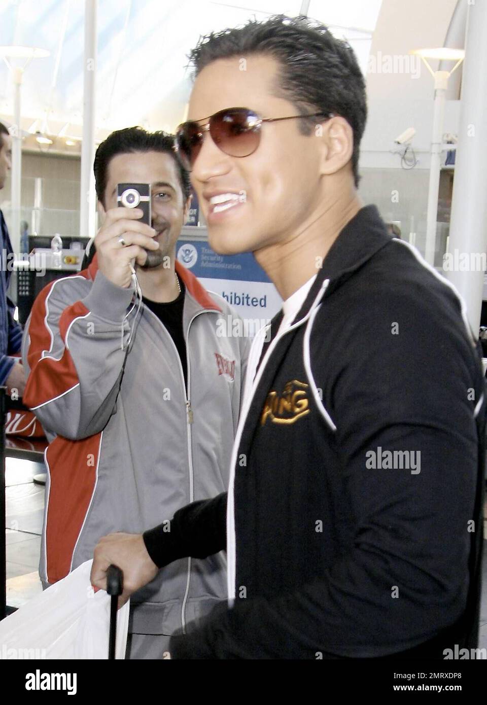 Mario Lopez heads through the line at a security checkpoint inside LAX ...
