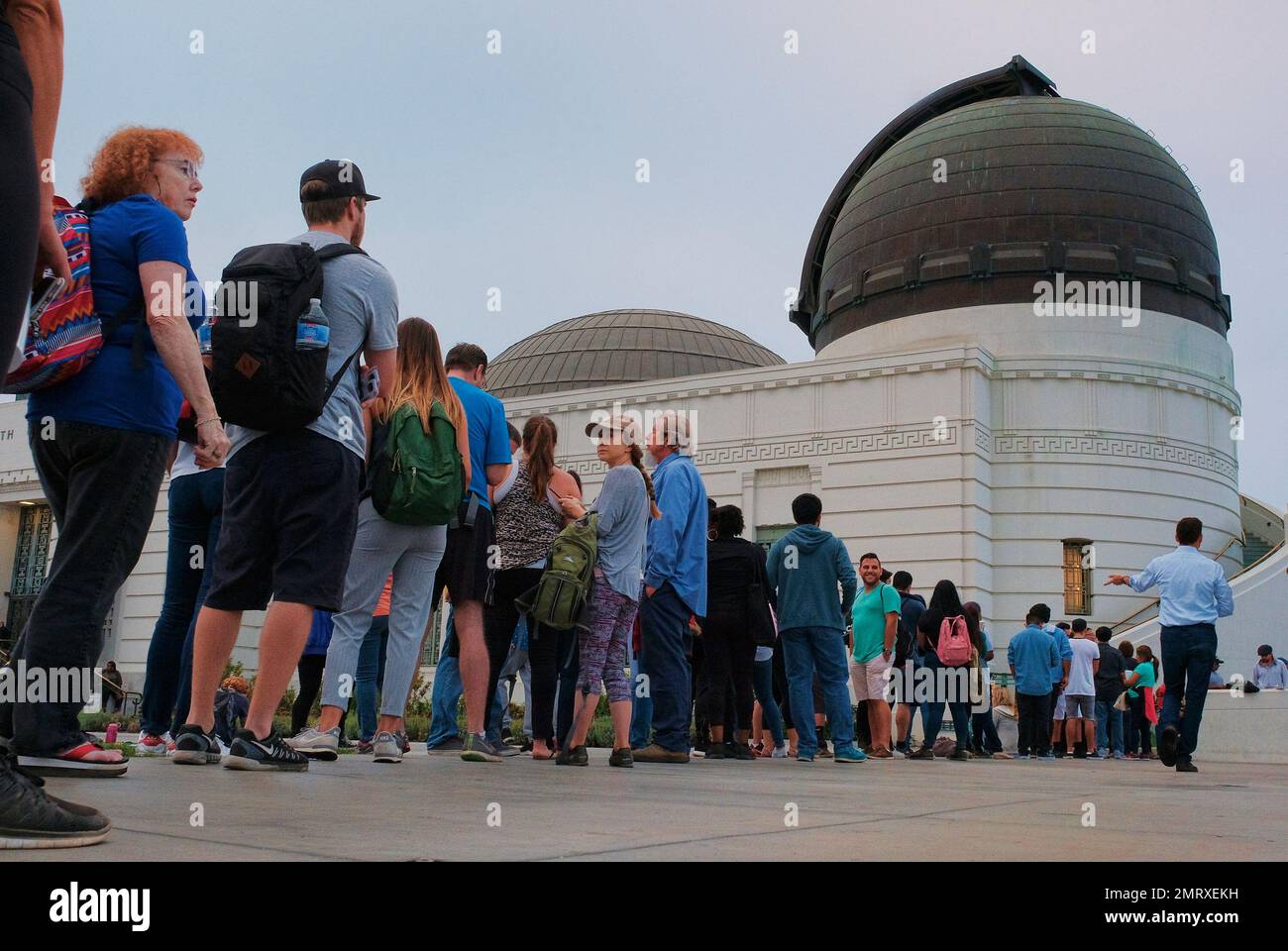 People wait in line to buy viewing glasses for the eclipse at the ...