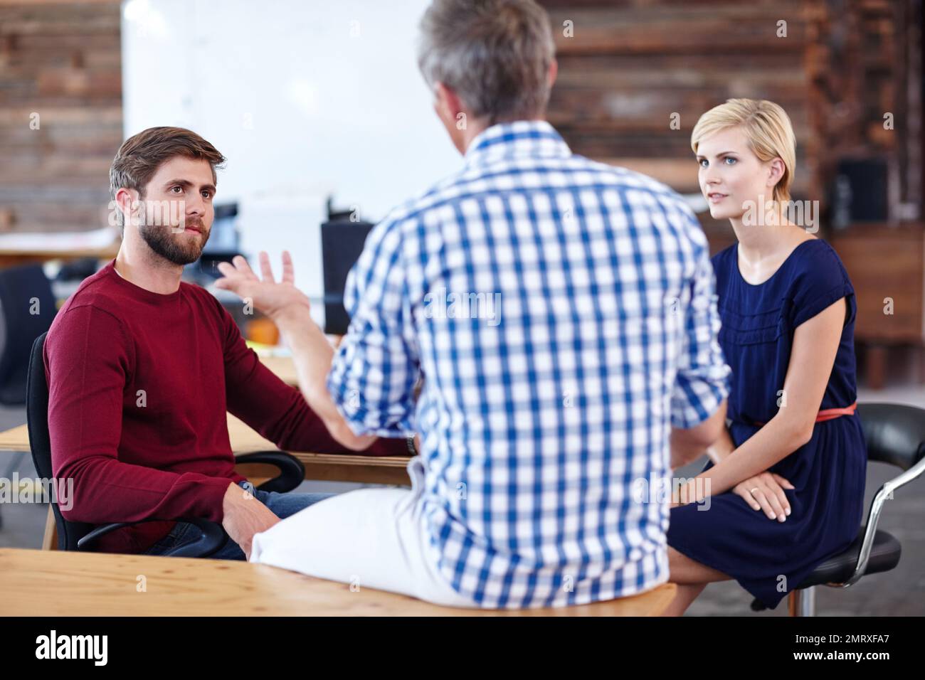 Collaborating on a design. A group of designers having an informal ...