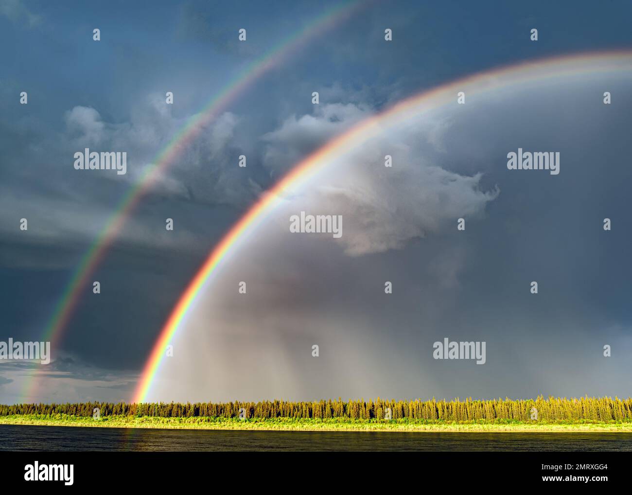 A bright double rainbow after rain during the day over the Vilyui River ...
