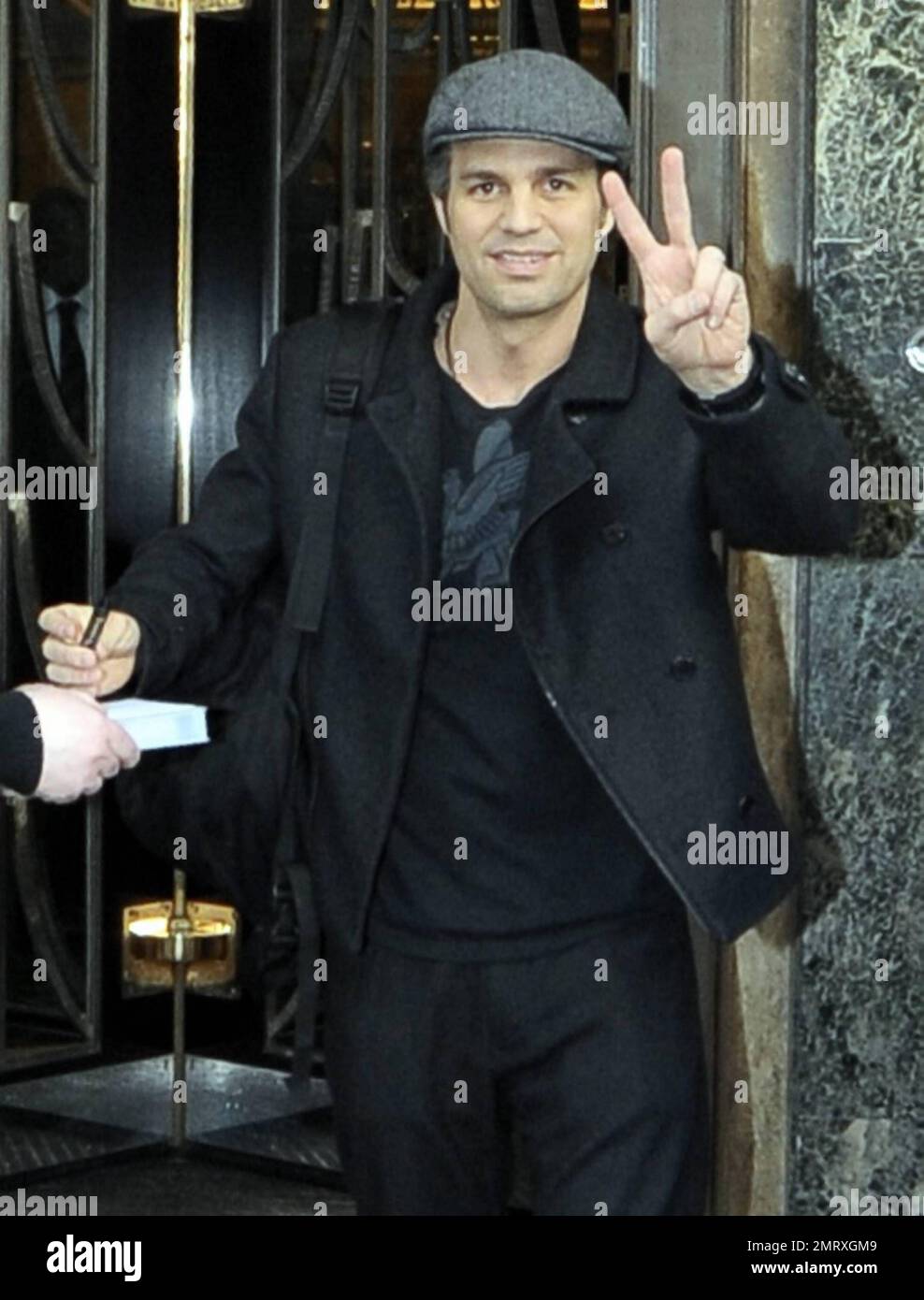 "The Kids Are Alright" star Mark Ruffalo flashes a peace sign while ...