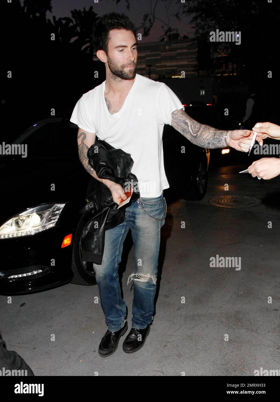 Adam Lavine shows off his tattoos as he arrives at the Staples Center ...