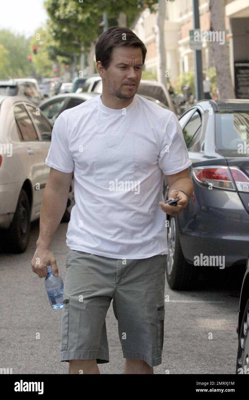 Mark Wahlberg heads toward his car after a visit to a medical building ...