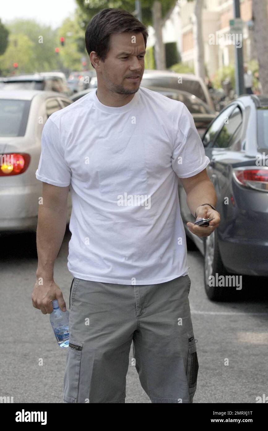 Mark Wahlberg heads toward his car after a visit to a medical building ...