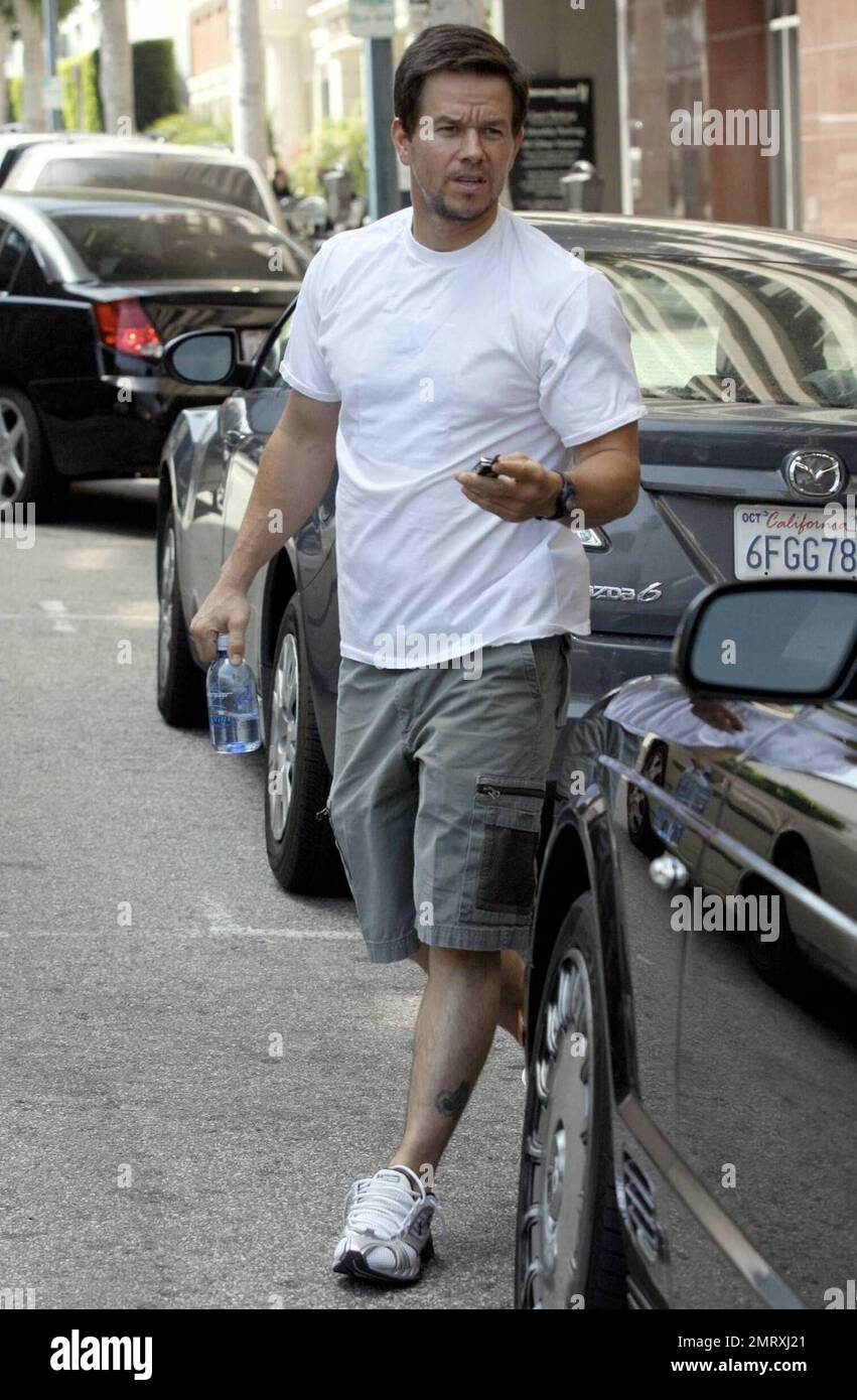 Mark Wahlberg heads toward his car after a visit to a medical building ...