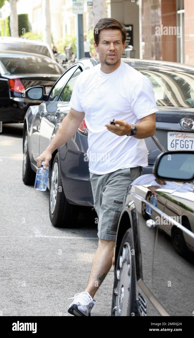Mark Wahlberg heads toward his car after a visit to a medical building ...