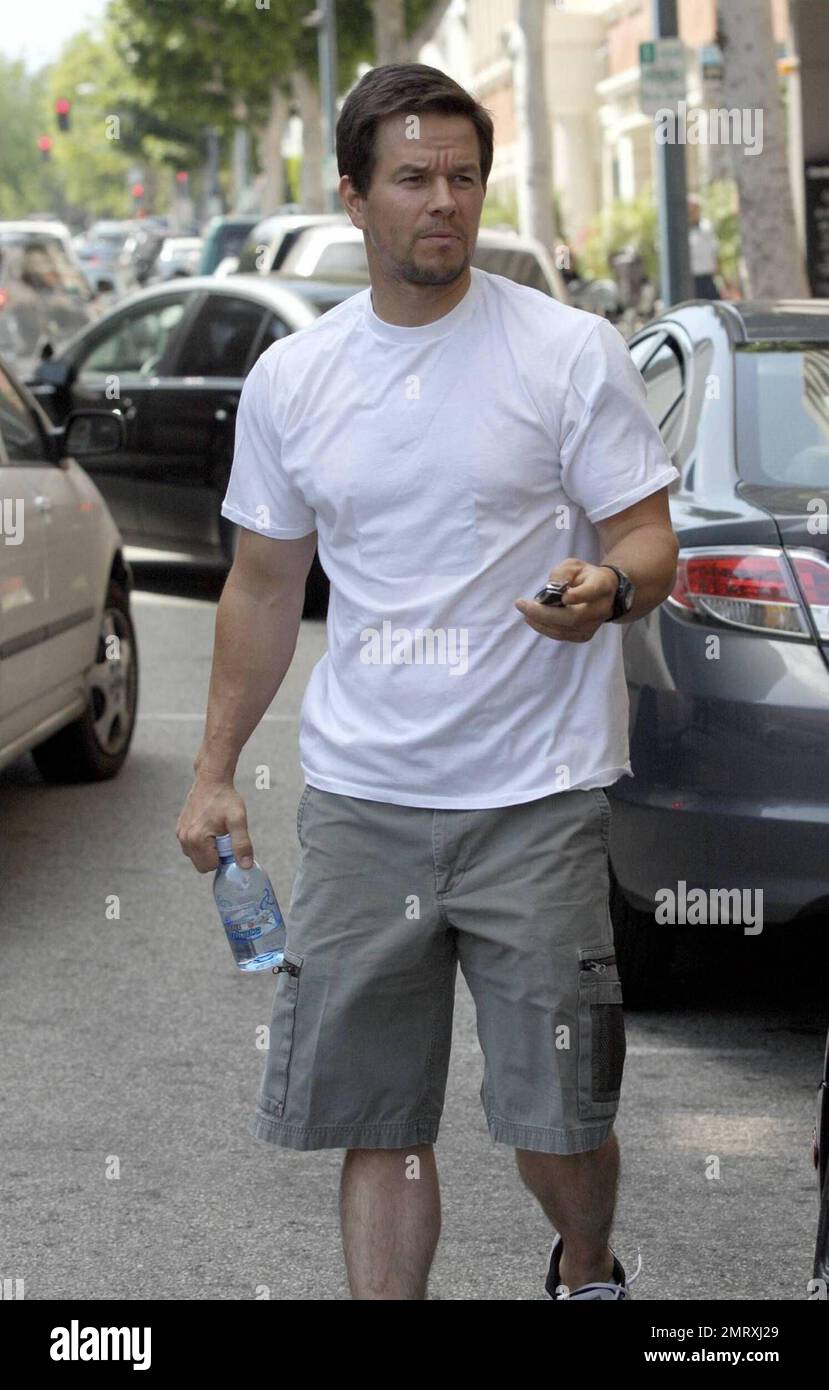 Mark Wahlberg heads toward his car after a visit to a medical building ...
