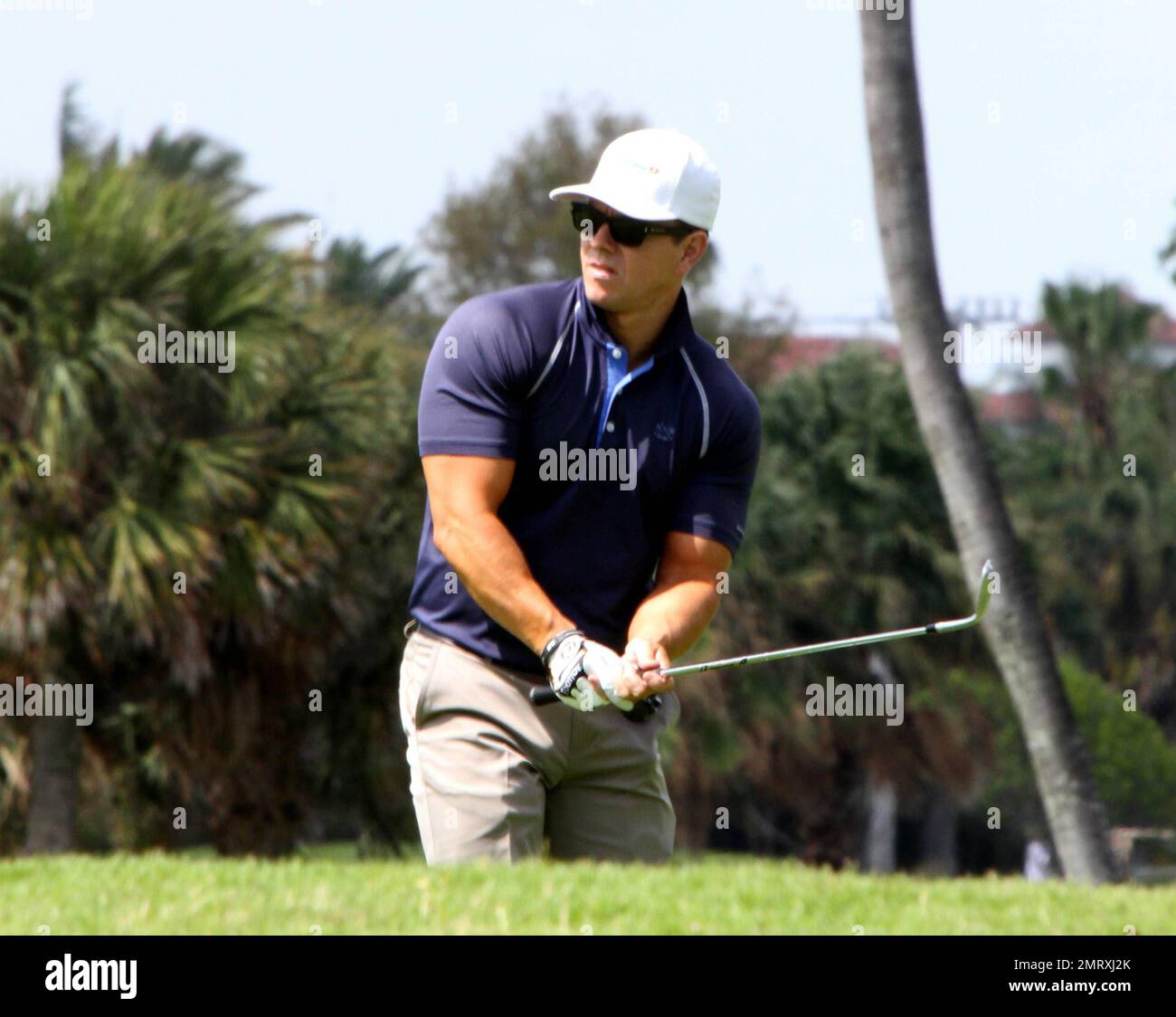 Taking a break from filming, actor Mark Wahlberg shows off his bulky ...