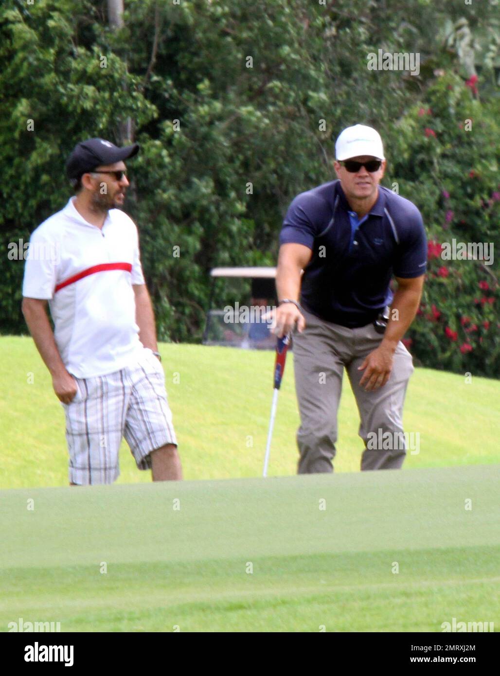 Taking a break from filming, actor Mark Wahlberg shows off his bulky ...