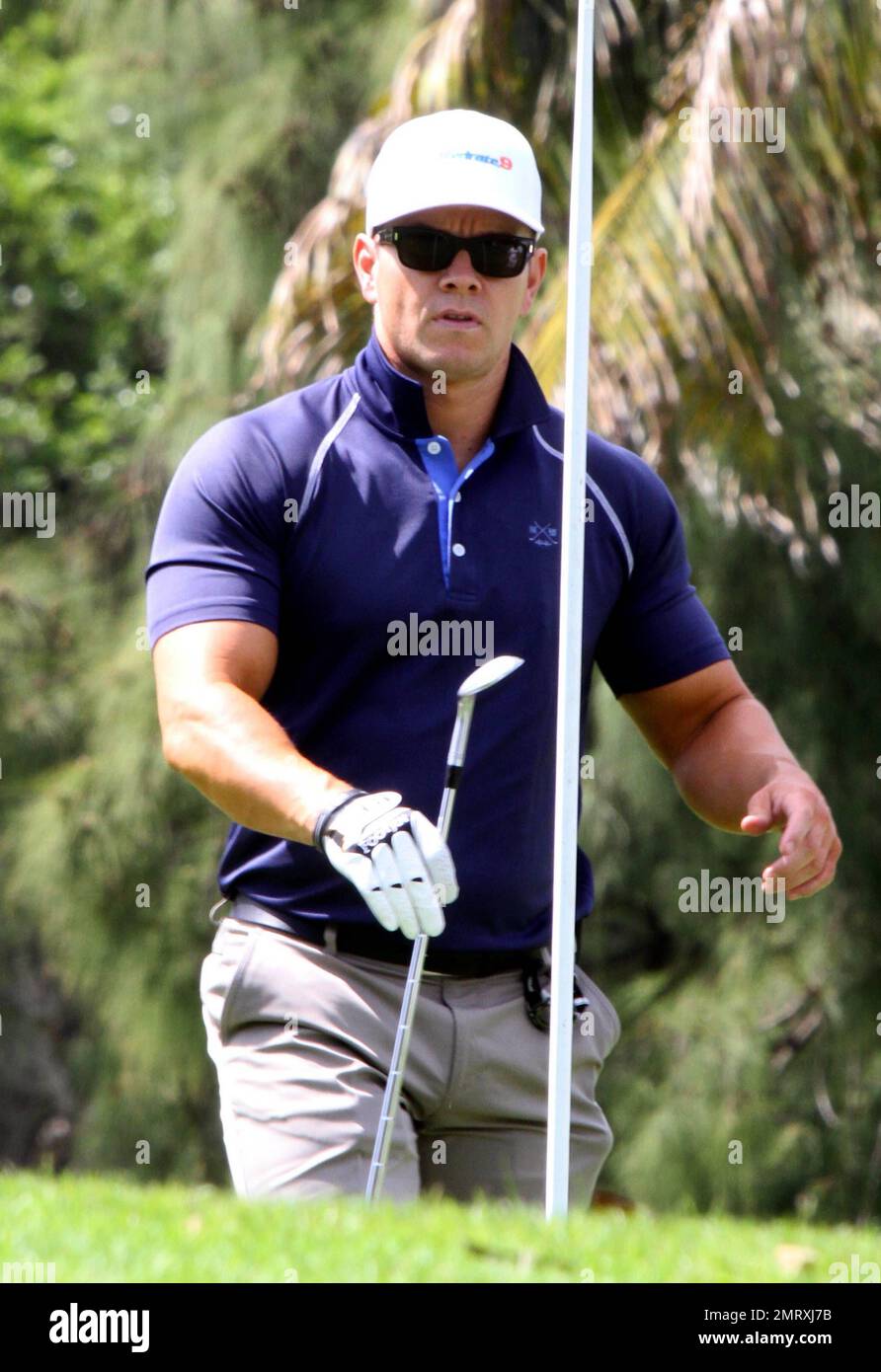 Taking a break from filming, actor Mark Wahlberg shows off his bulky ...