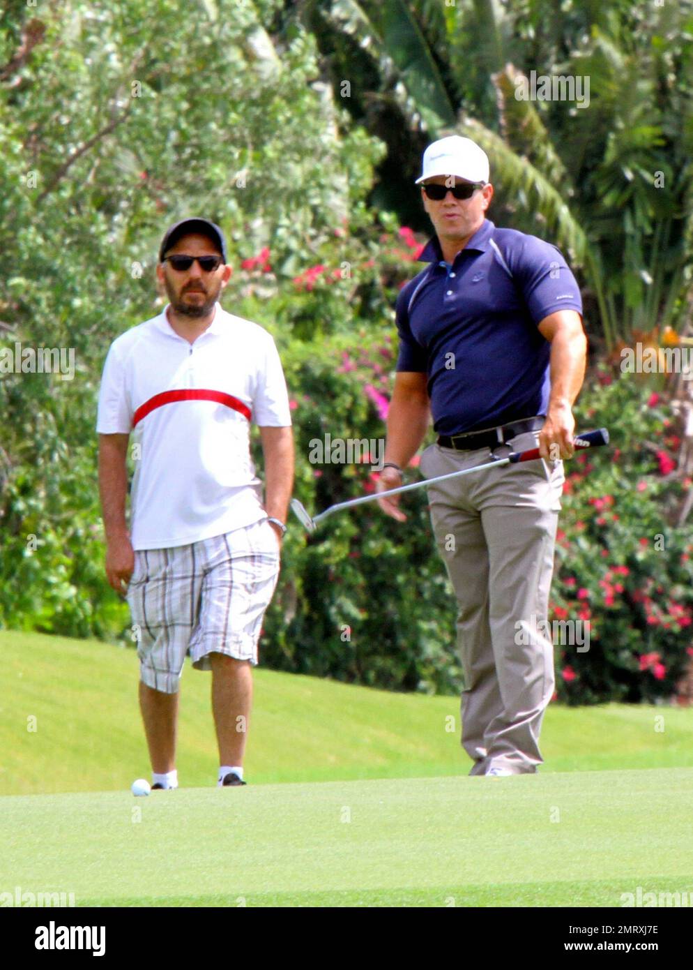 Taking a break from filming, actor Mark Wahlberg shows off his bulky ...