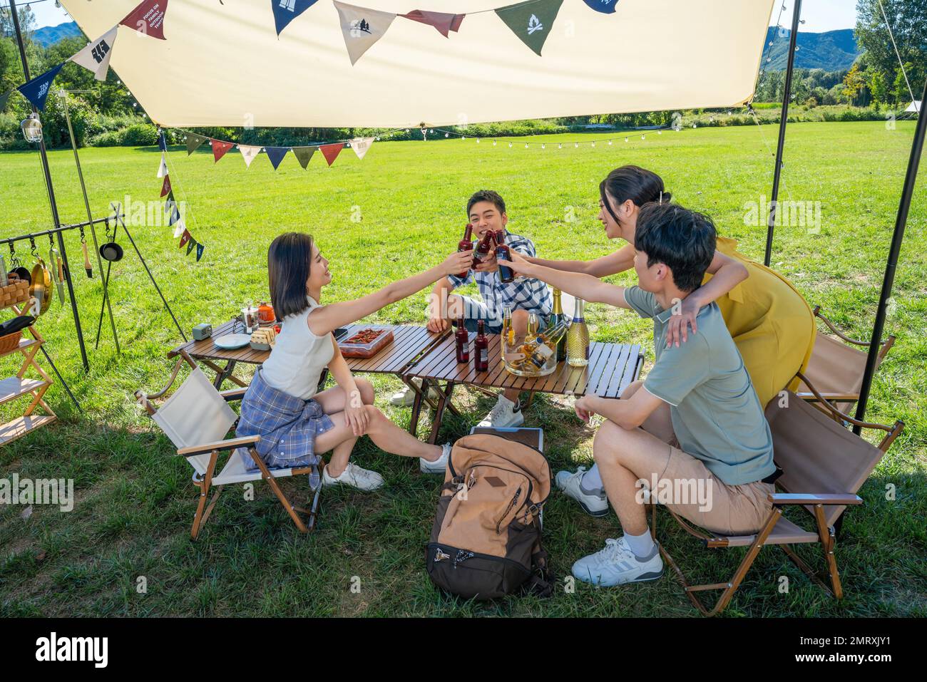 A group of people sat under the awning Stock Photo - Alamy