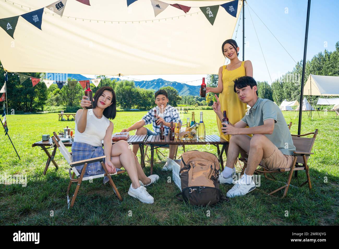 A group of people sat under the awning Stock Photo - Alamy