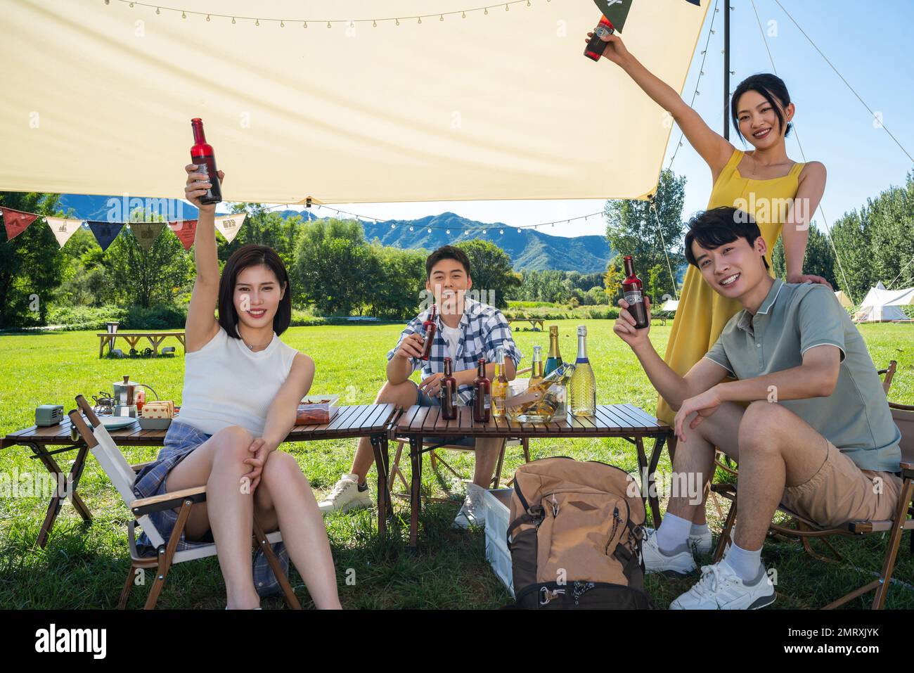A group of people sat under the awning Stock Photo - Alamy