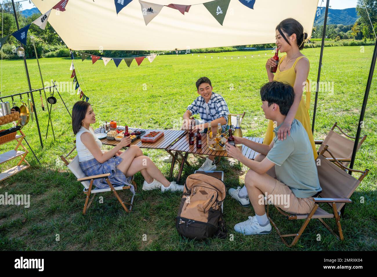 A group of people sat under the awning Stock Photo - Alamy