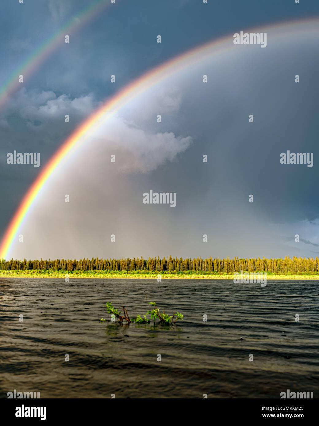 Double rainbow over the Vilyui River with raindrops against the sky and ...