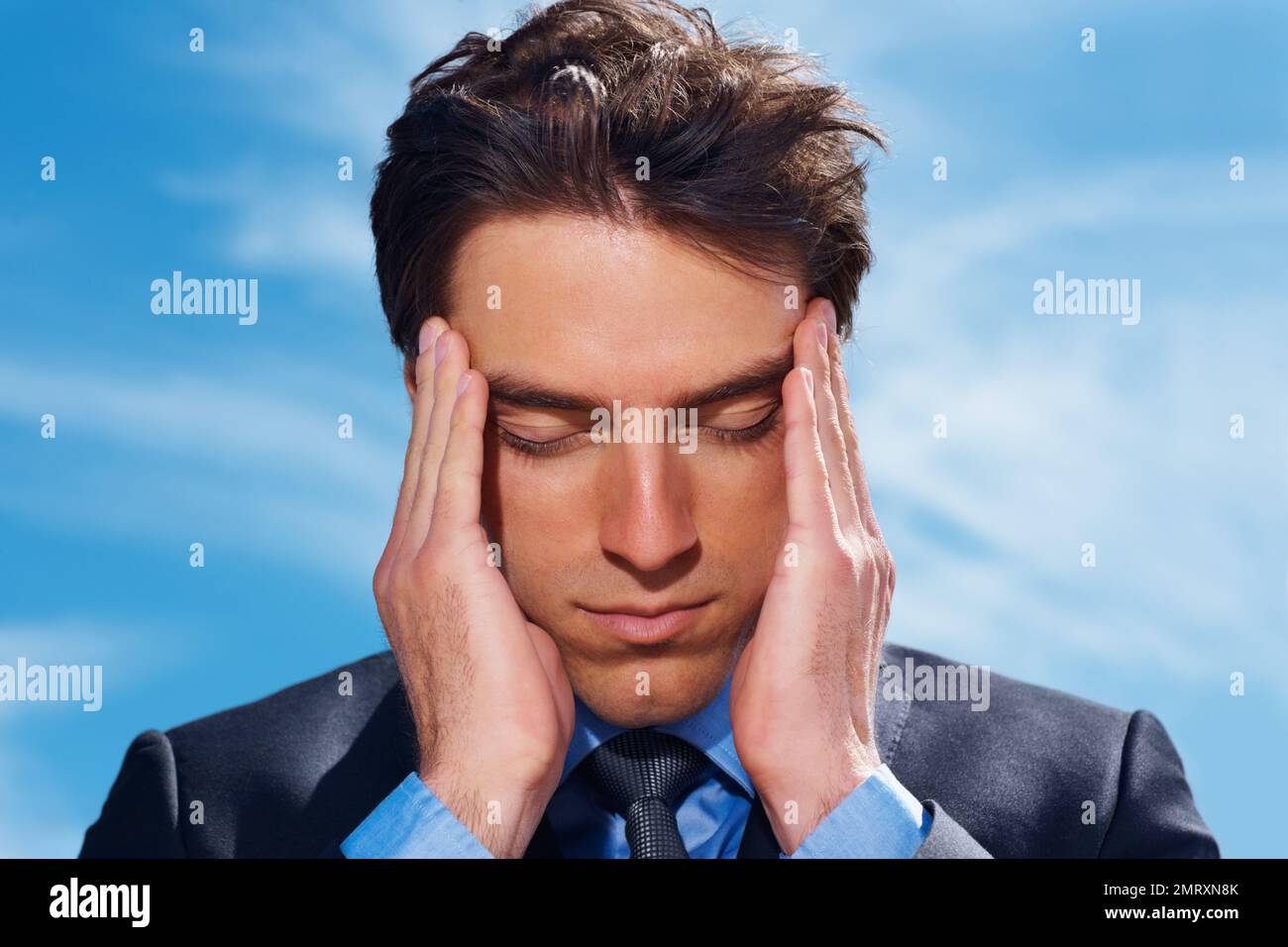 Stressed man with hands on forehead showing sadness and despair. Young ...