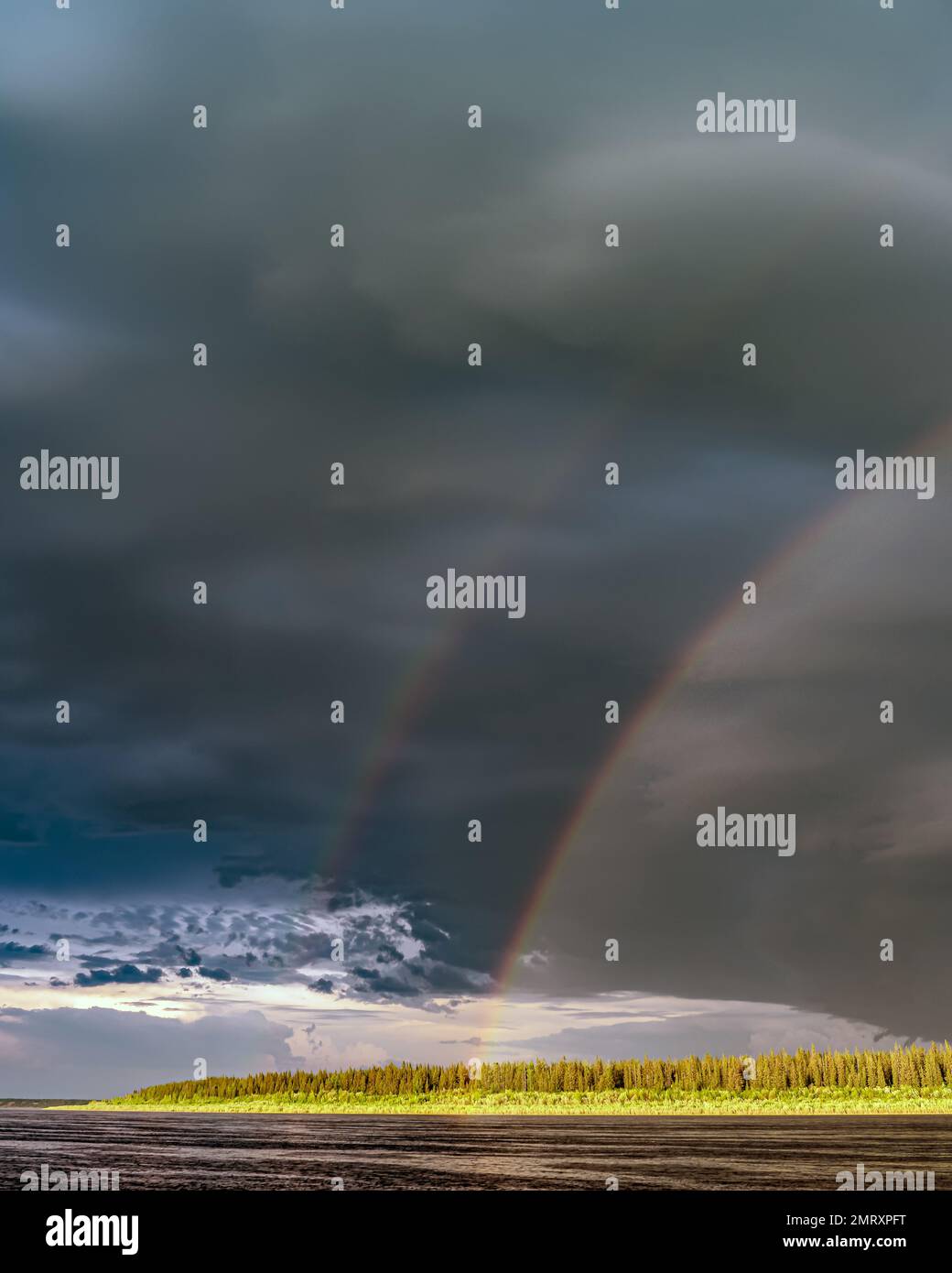 Double rainbow over the Vilyui River with raindrops against a blue sky ...
