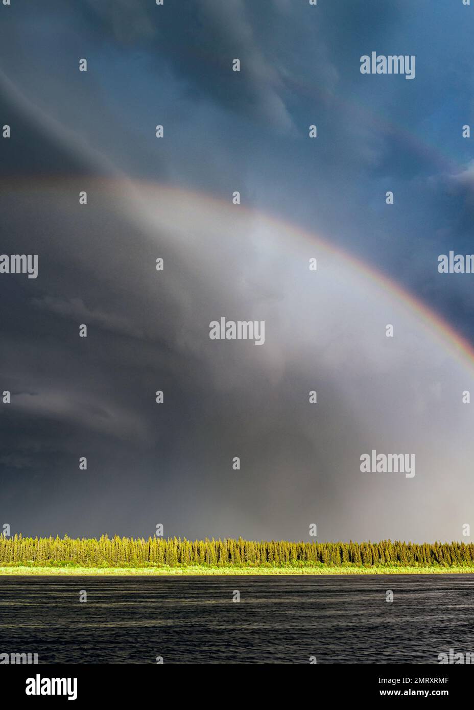 Double rainbow over the Vilyui River with raindrops against a blue sky ...