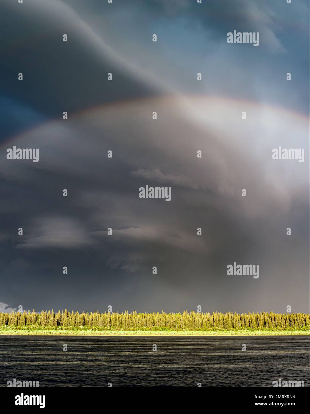 A double rainbow over the Vilyui River with raindrops against a blue ...