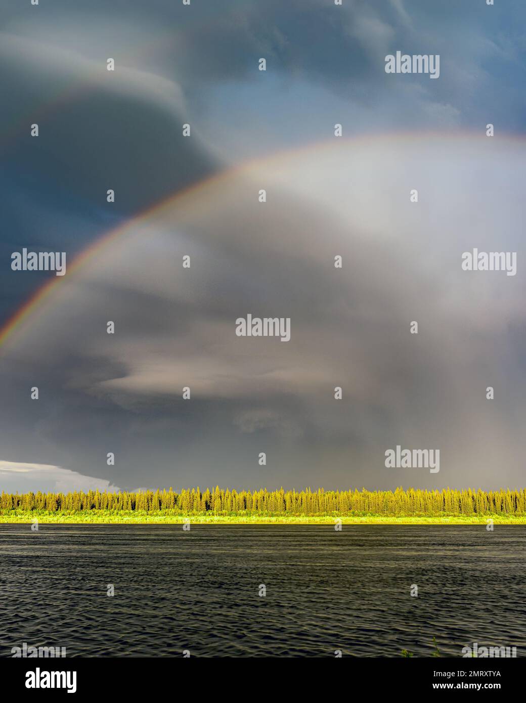 Double rainbow over the Vilyui River with raindrops against a blue sky ...