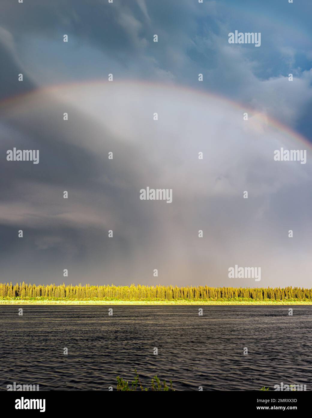 A double rainbow over the Vilyui River after rain against a blue sky ...