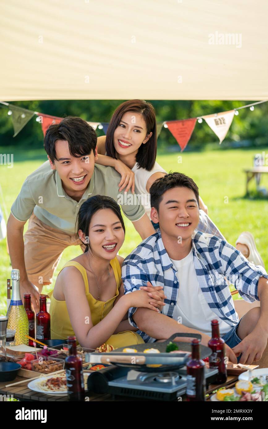 A group of people sat under the awning Stock Photo - Alamy