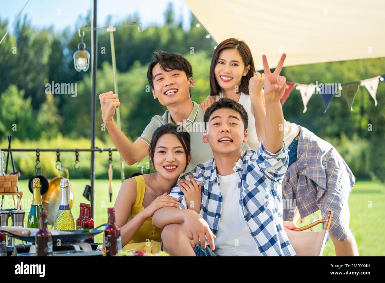 A group of people sat under the awning Stock Photo - Alamy