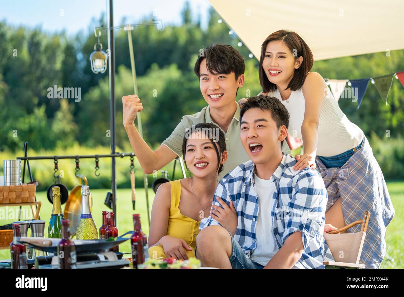A group of people sat under the awning Stock Photo - Alamy