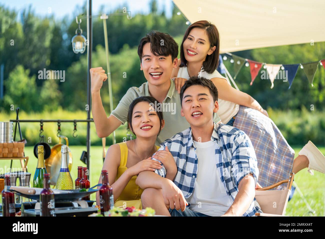 A group of people sat under the awning Stock Photo - Alamy