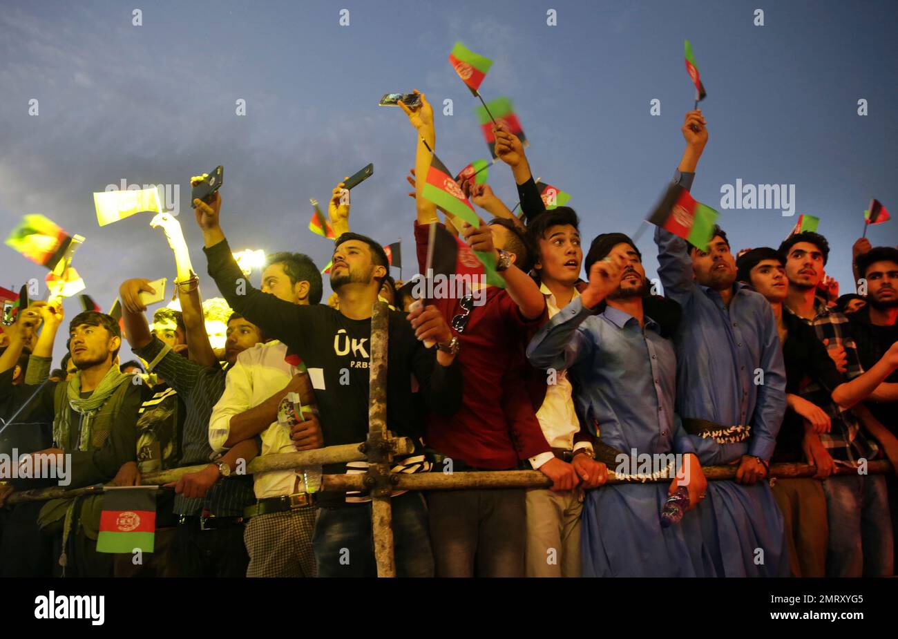 Male fans watch as Afghan female singer Aryana Sayeed performs during a ...