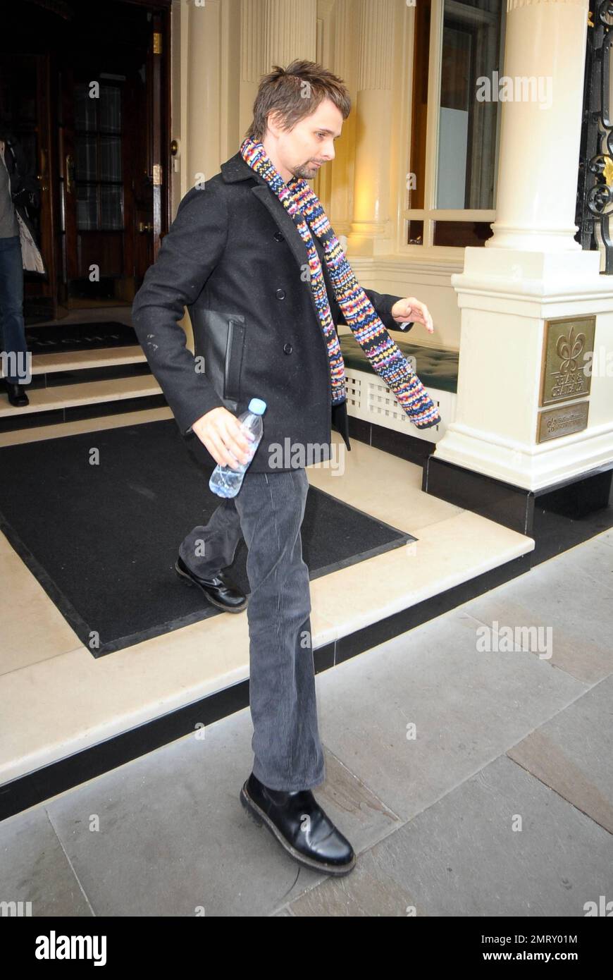 Wearing a very colorful scarf with an otherwise all-black outfit, Matt ...