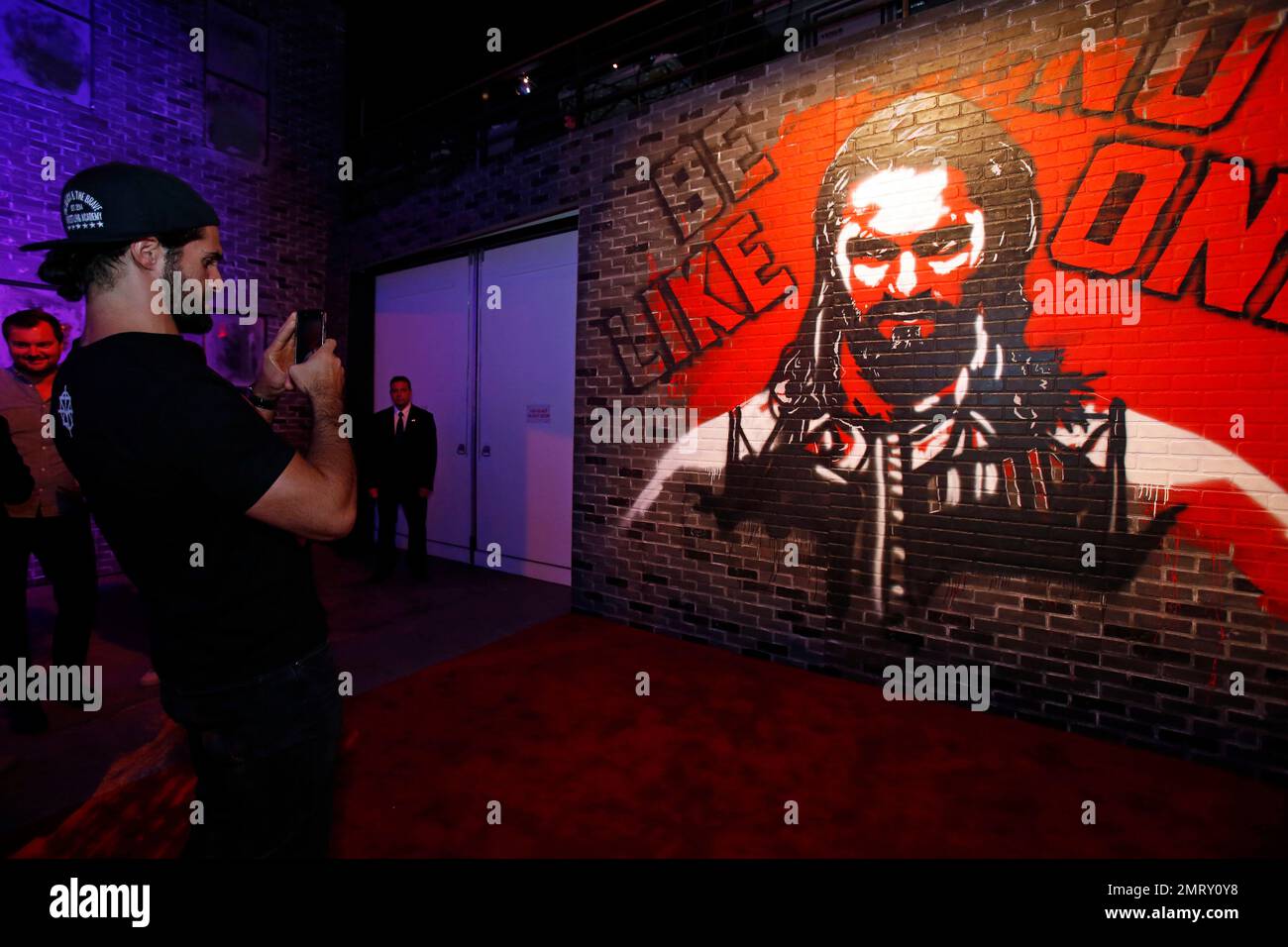 WWE 2K18 Cover Superstar Seth Rollins takes a photo of a mural painted ...