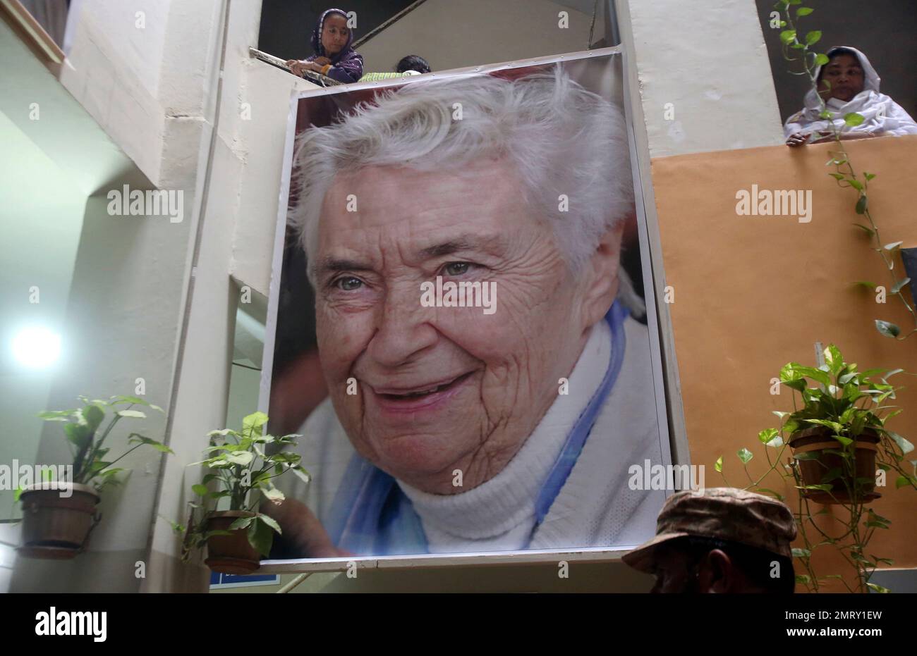 Women look down next to large portrait of Ruth Pfau, a German physician ...
