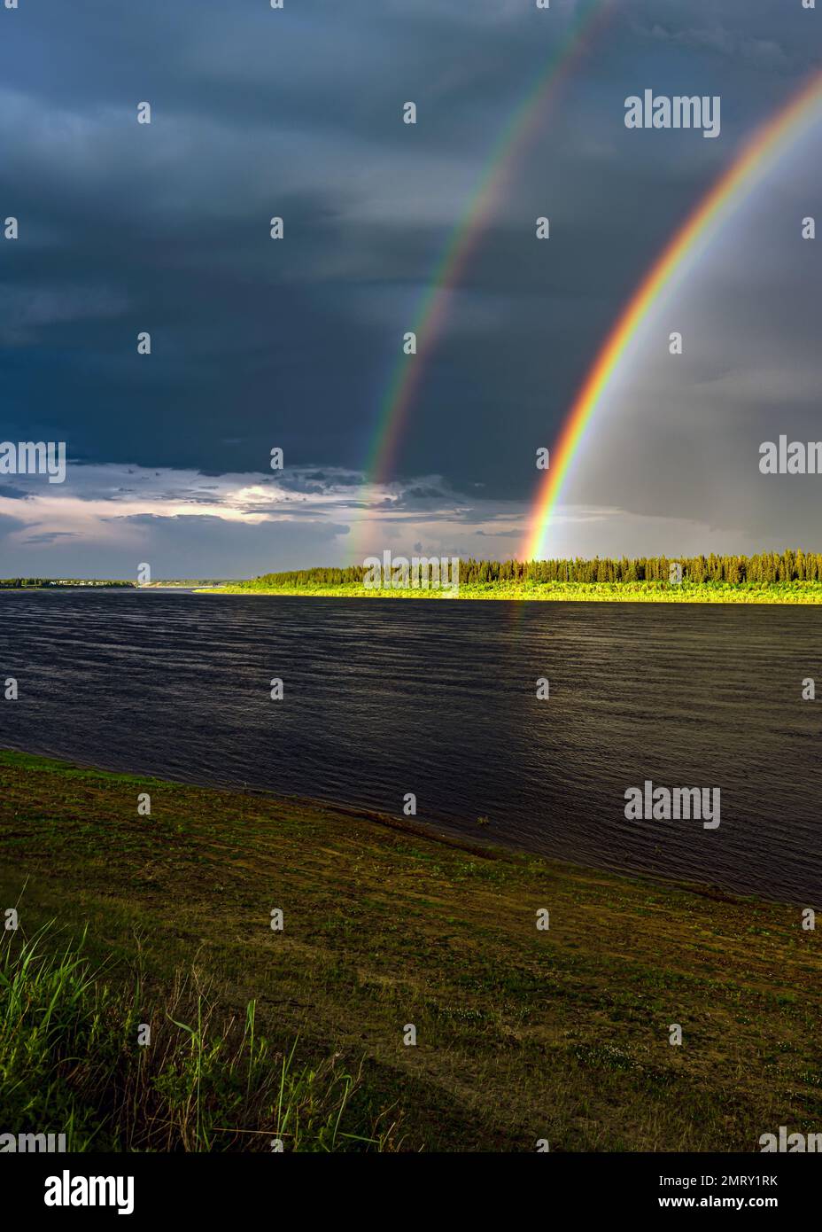 Double rainbow over the Vilyui River after rain against a sky with ...