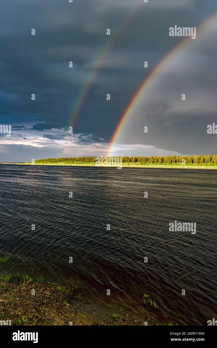 Double rainbow over the Vilyui River after rain against a sky with ...