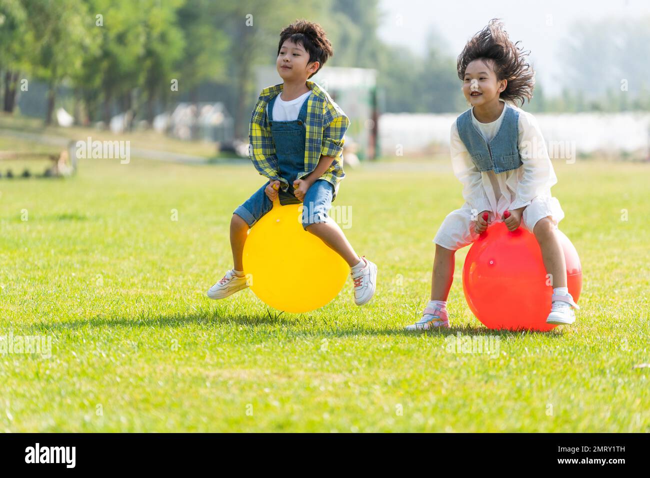 The two children playing games on the grass Stock Photo - Alamy