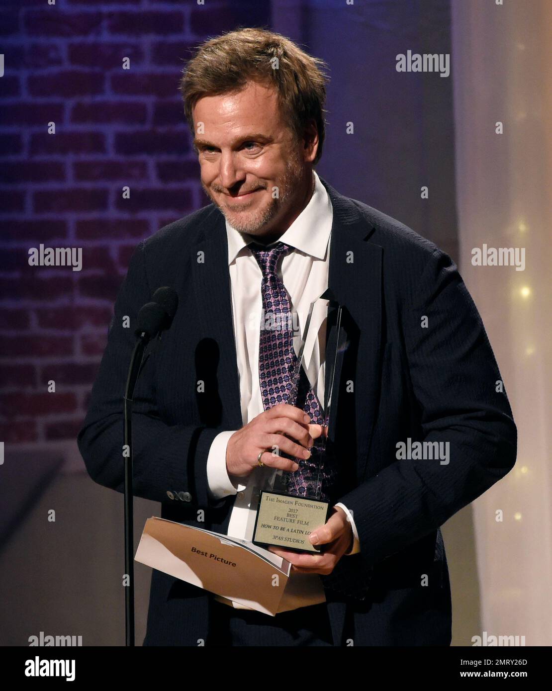 Producer Ben Odell accepts the award for best feature film for "How to Be a Latin Lover" at the ...
