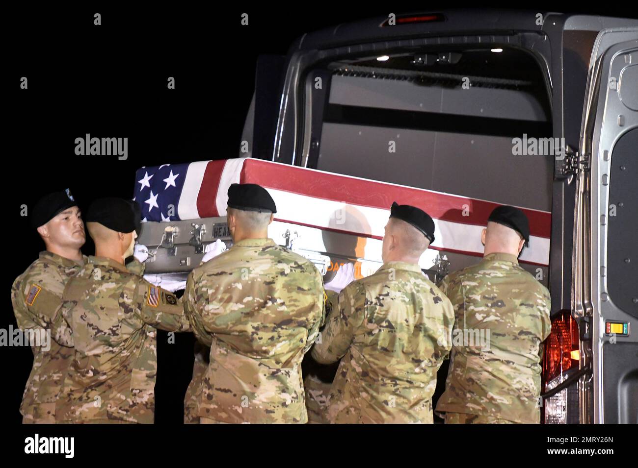 An Army carry team moves a transfer case containing the remains of ...