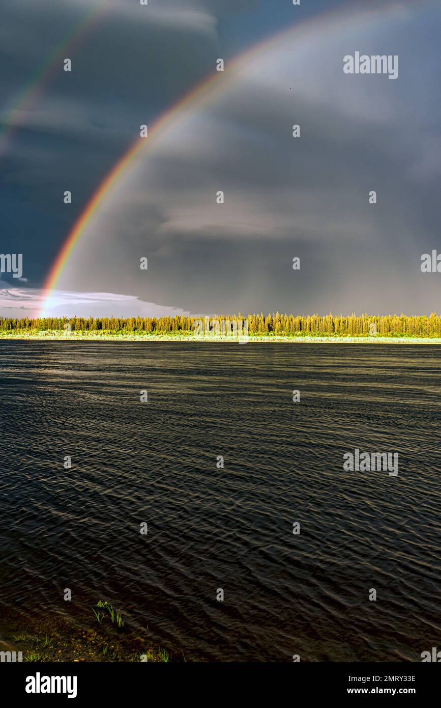 Double rainbow over the Vilyui River after rain against a sky with ...