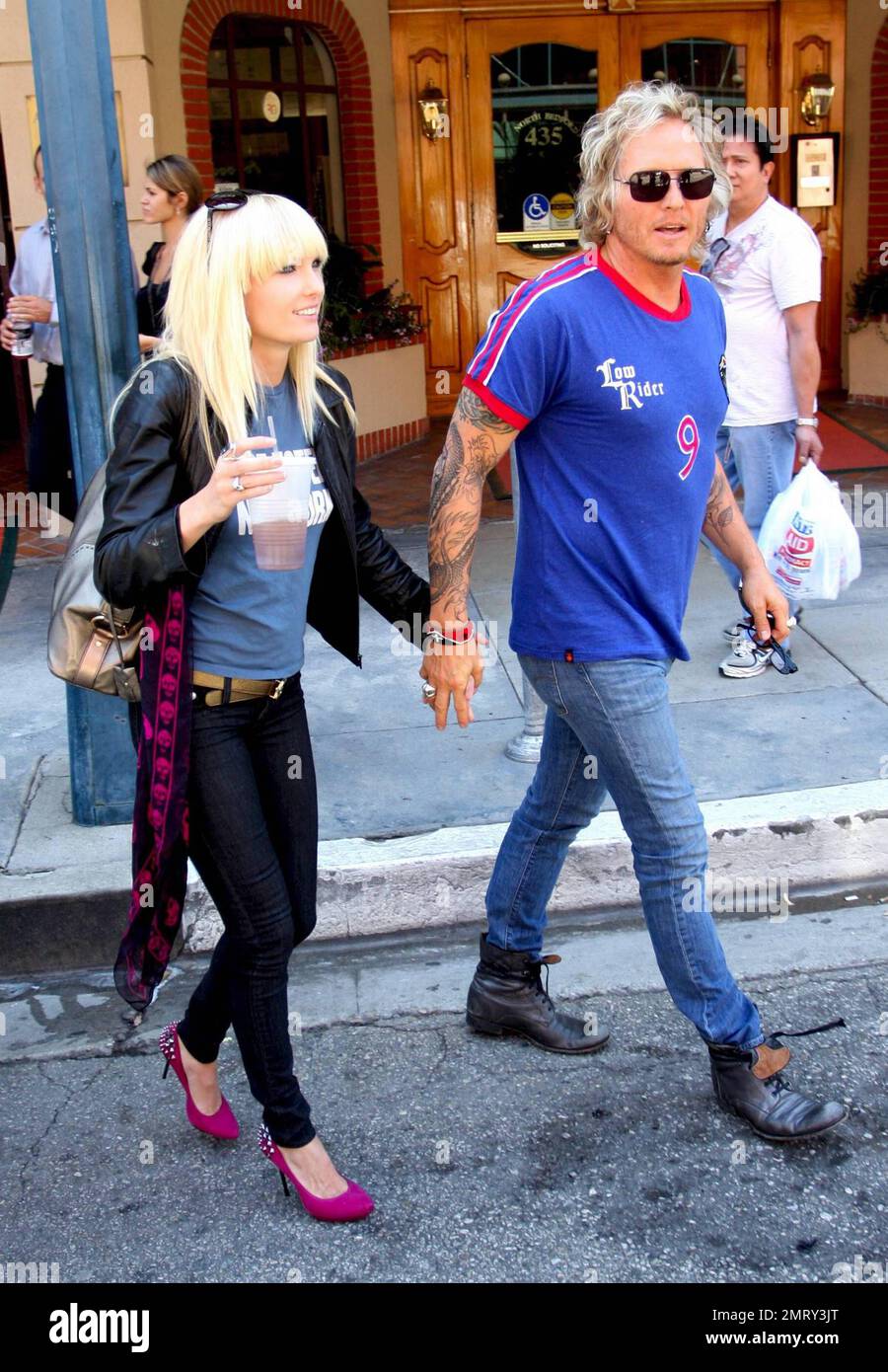 Former Guns N' Roses and Velvet Revolver drummer Matt Sorum holds hands ...