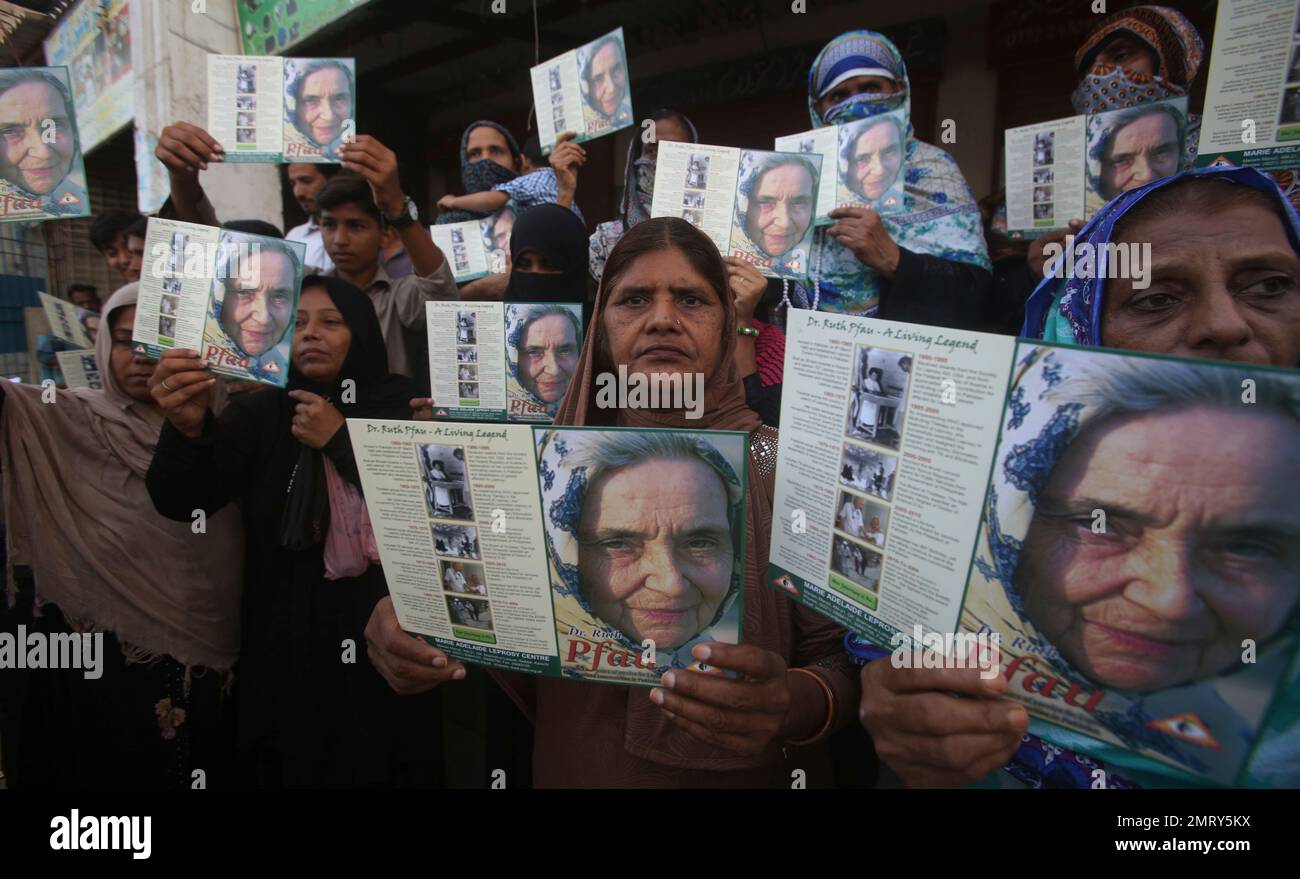 People hold pictures of Ruth Pfau, a German doctor and nun who devoted ...